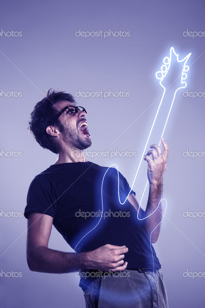 Young man playing imaginary guitar and squealing — Stock Photo ...