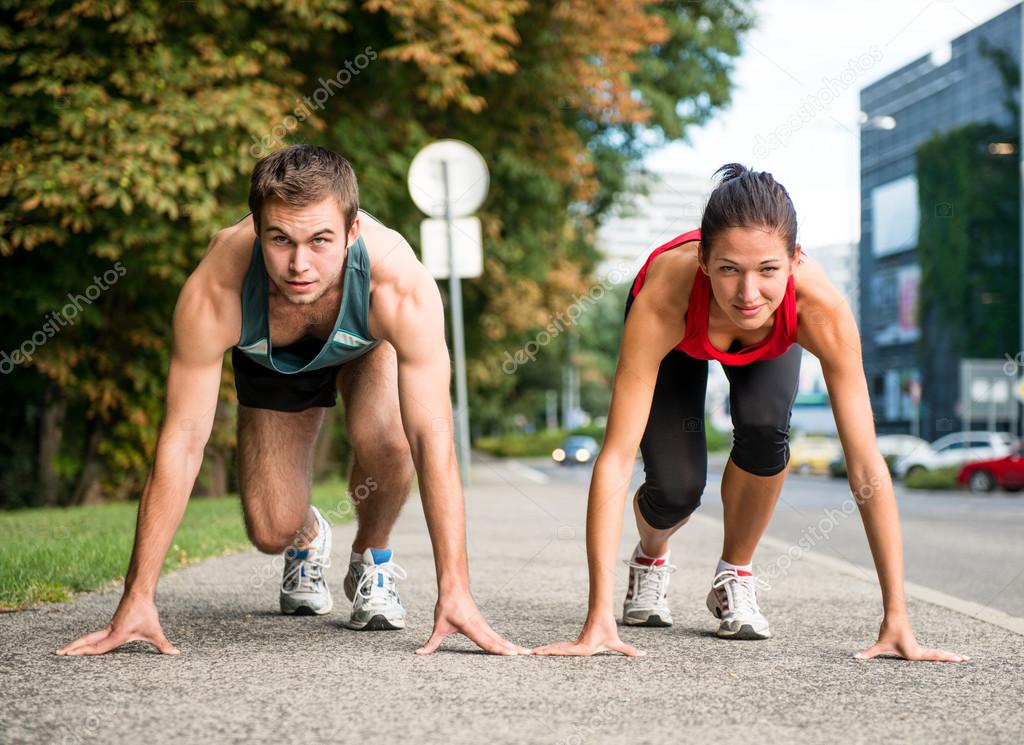 Rivalry - young couple competing in running — Stock Photo © martinan ...