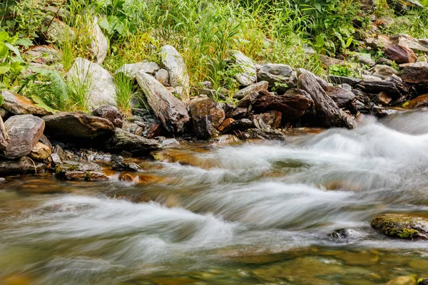 long exposure of a River stream on mountain valley. Slow motion surface ...