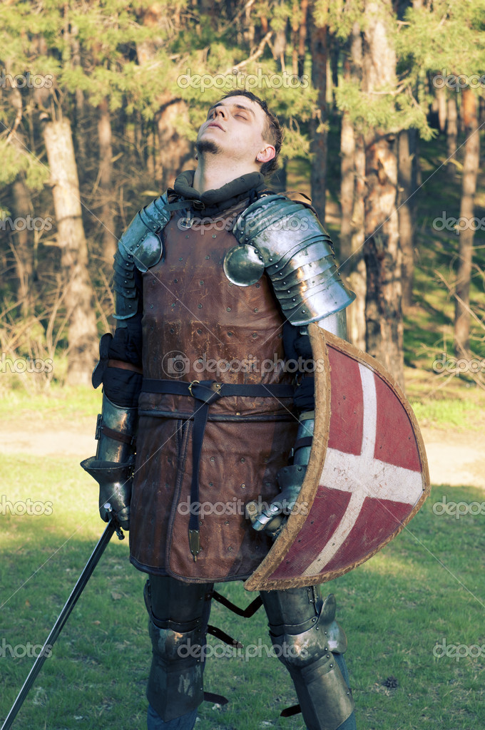 Knight holding sword in a forest — Stock Photo © Oleksminyaylo1 #31074973