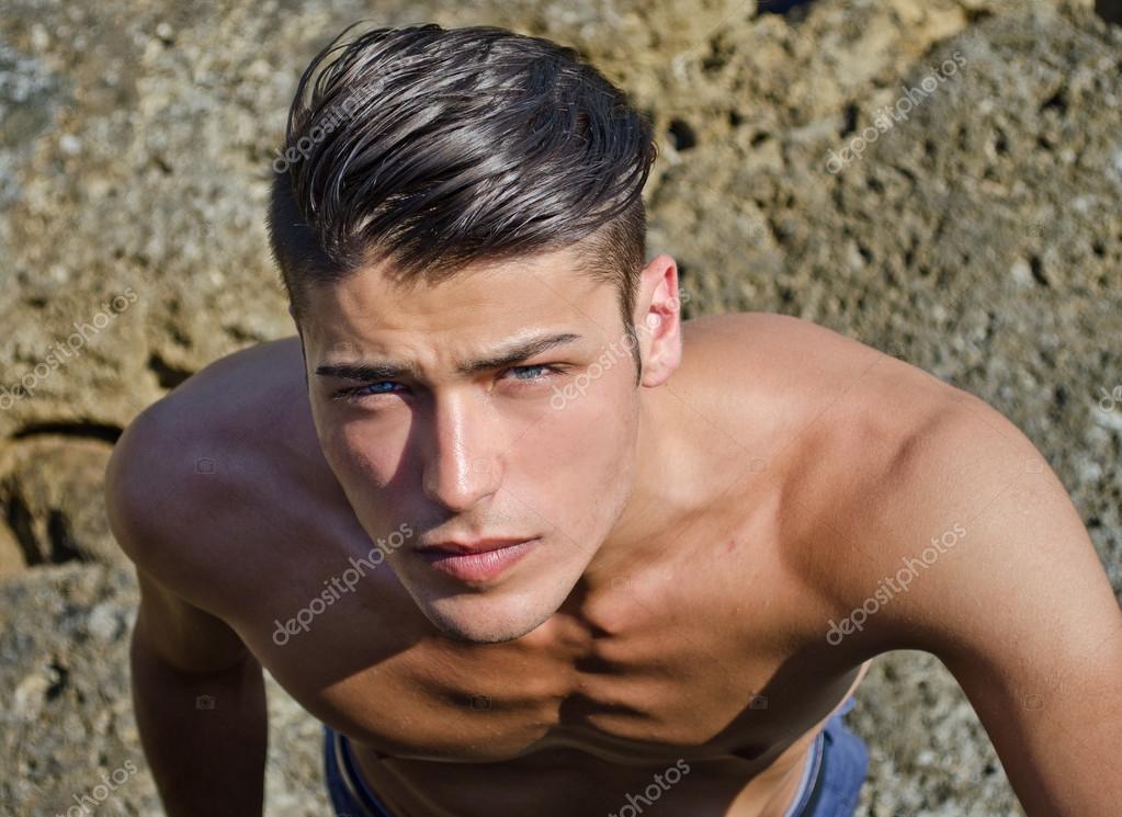 Handsome young man looking up in camera — Stock Photo © artofphoto ...