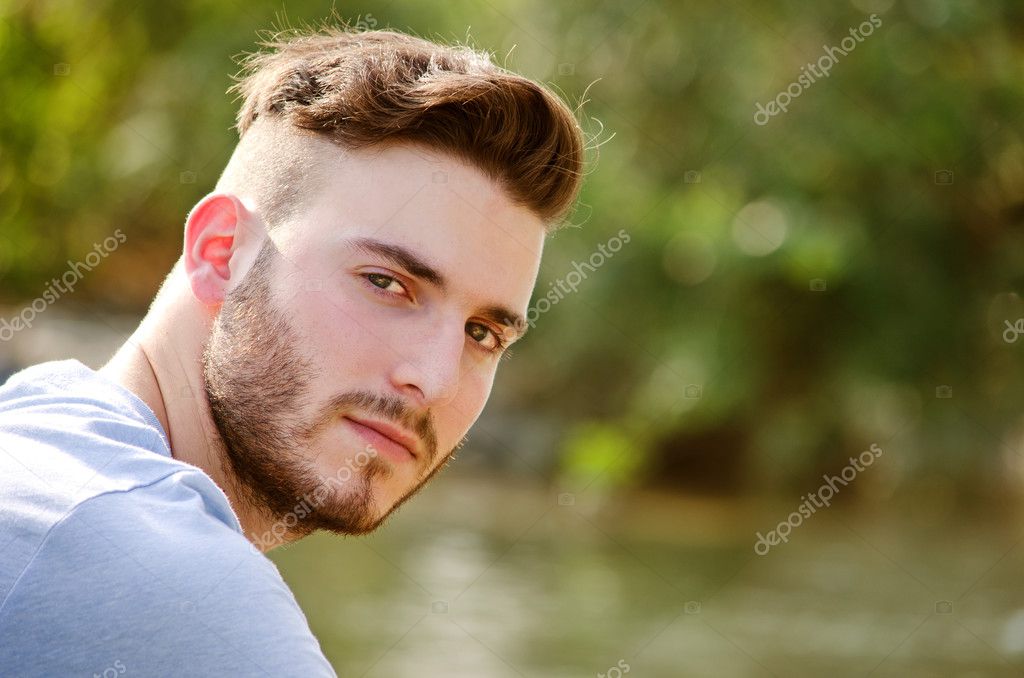 Portrait of handsome young man outdoors in nature Stock Photo by ...