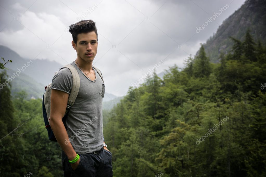 Handsome athletic young man with backpack in mountains — Stock Photo ...