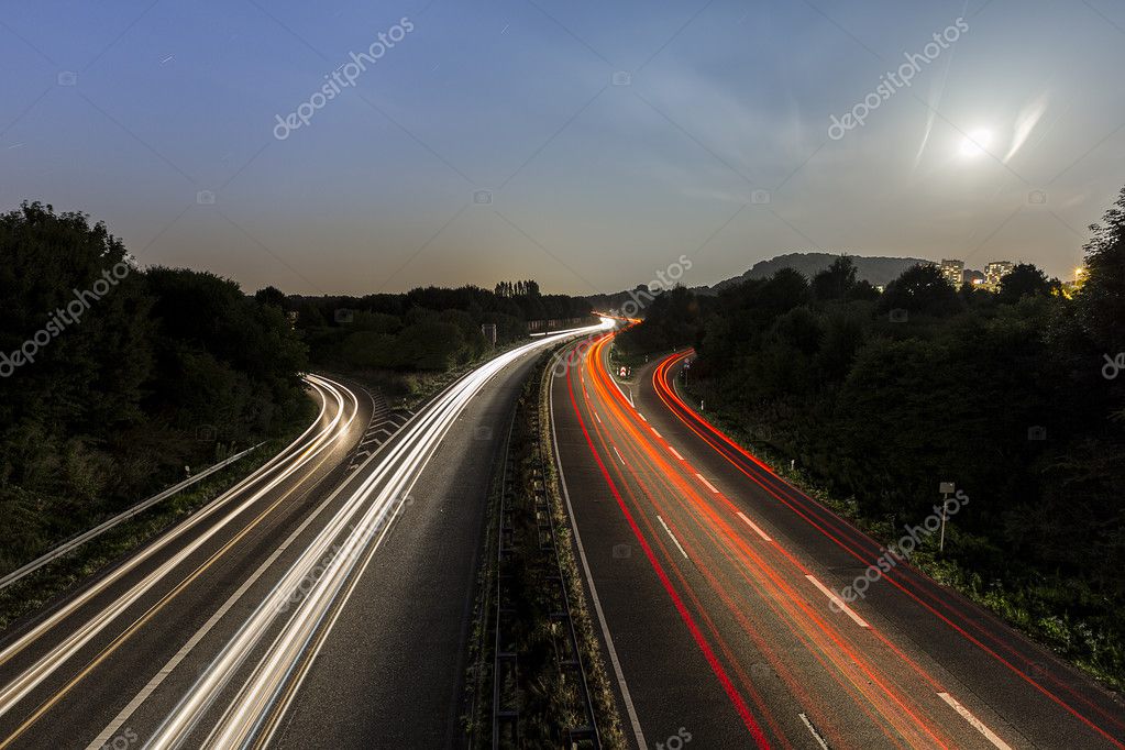 Long time exposure freeway cruising car light trails streaks of light ...