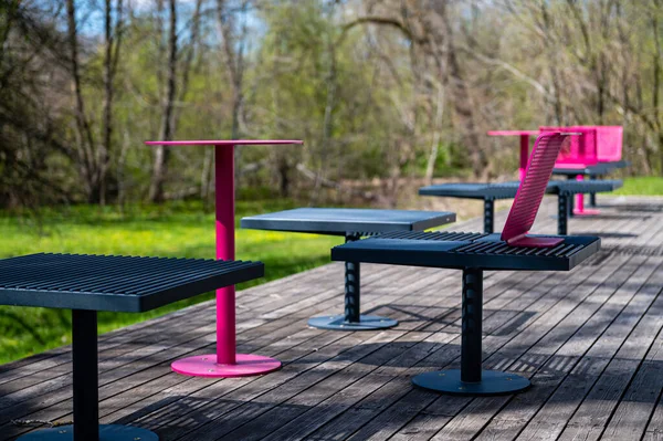 colorful metal benches and tables on the terrace on a sunny day - Stock ...