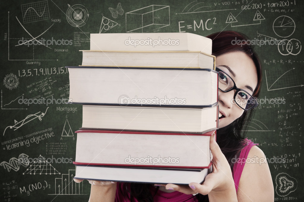 Close-up female student bring stack of books in class — Stock Photo ...