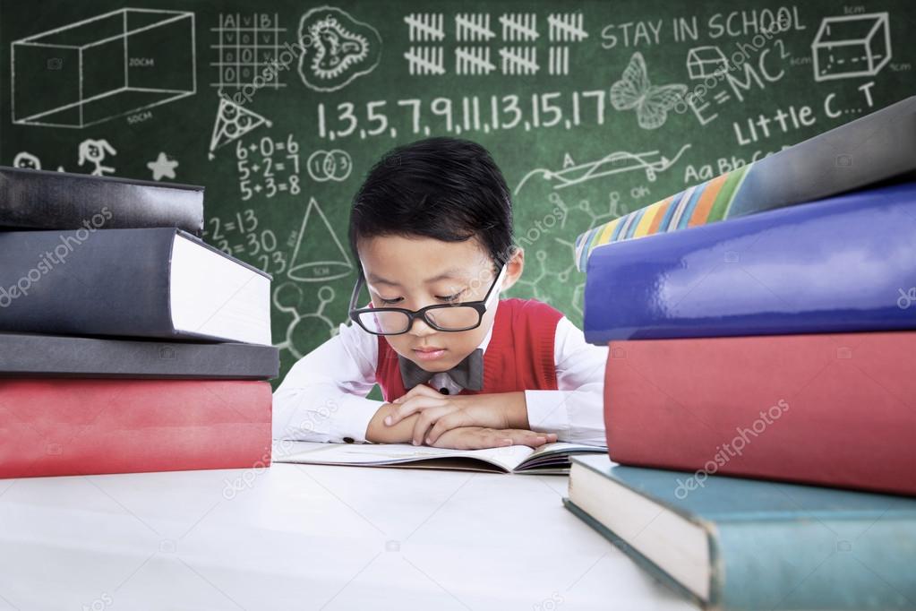Close-up boy student reading books in class — Stock Photo ...