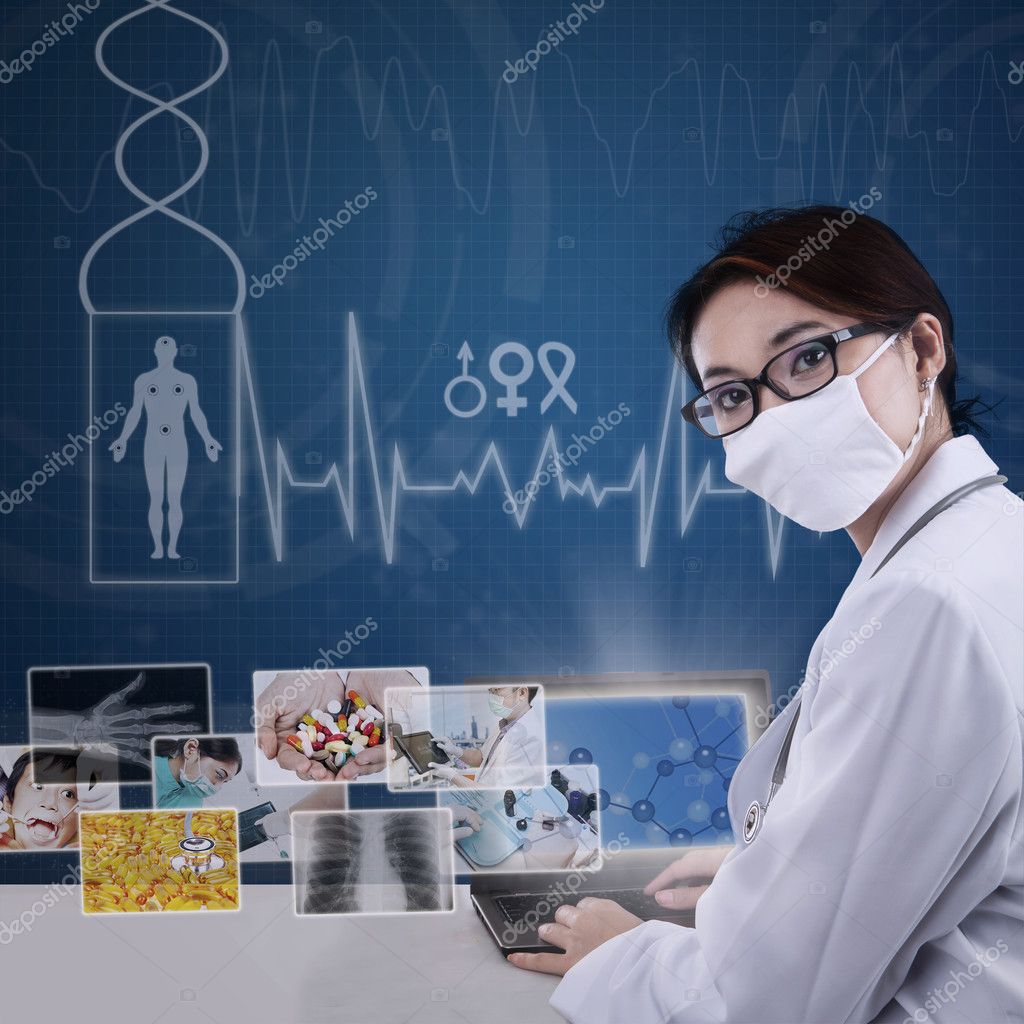 Attractive modern doctor working on laptop — Stock Photo © realinemedia ...