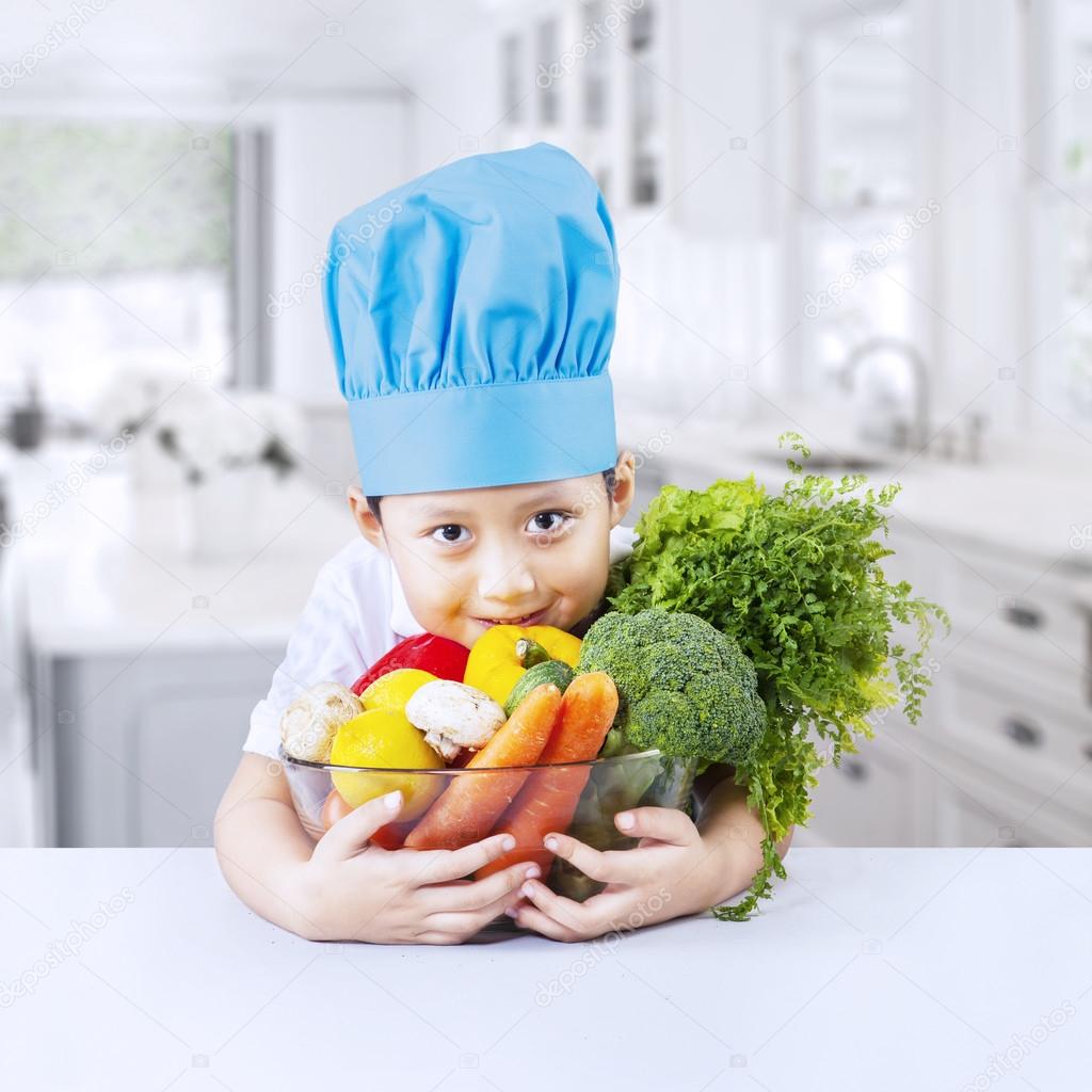 Boy chef and vegetable at home — Stock Photo © realinemedia #30111789