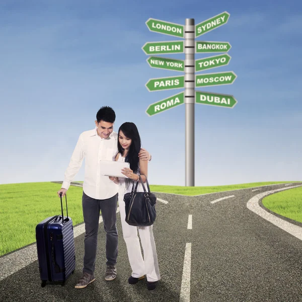 Choosing destination with digital tablet - Stock Image - Everypixel
