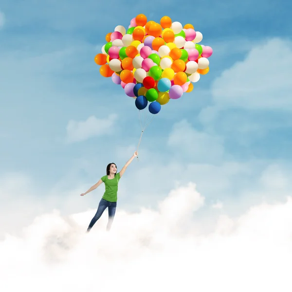 Woman flying with balloons - Stock Image - Everypixel