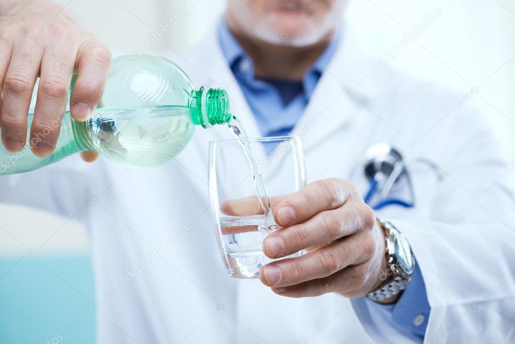 Doctor pouring water — Stock Photo © stokkete #41273845