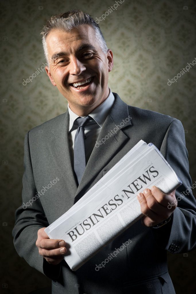 Businessman holding newspaper — Stock Photo © stokkete #41350791
