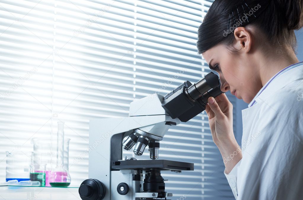 Female researcher using microscope Stock Photo by ©stokkete 42237565