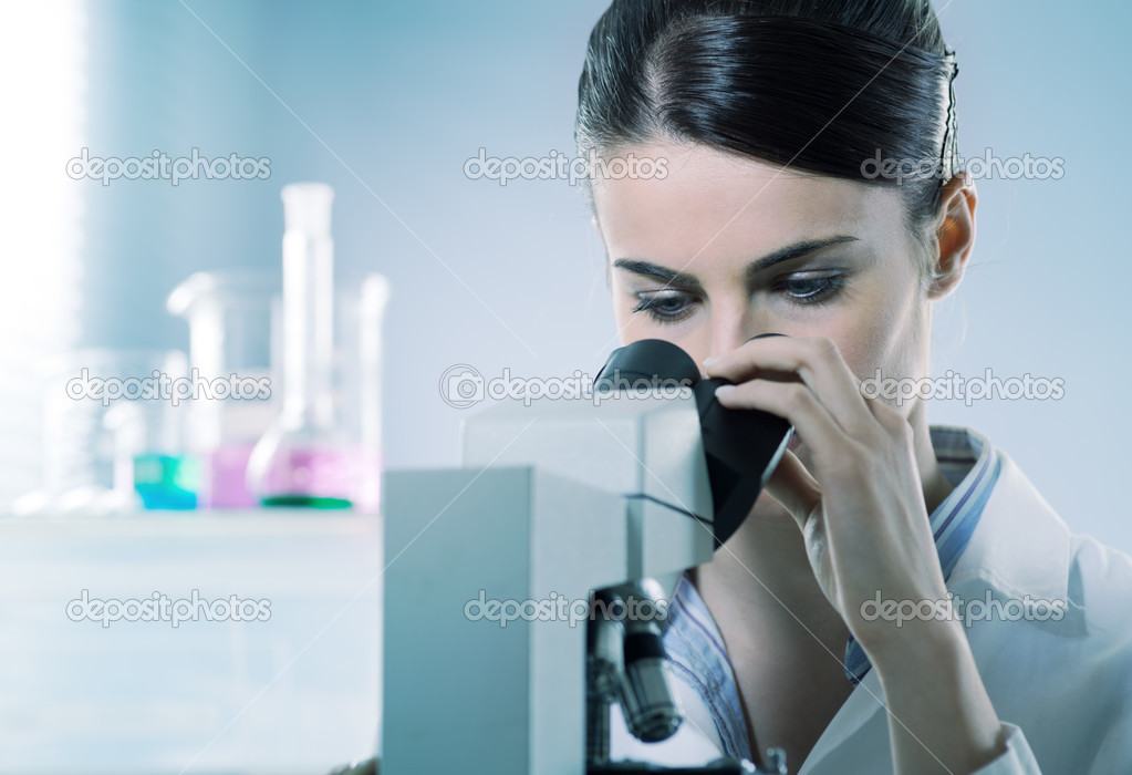 Female researcher using microscope Stock Photo by ©stokkete 45696145