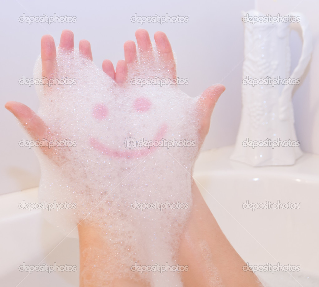 Smile on soap foam on hands Stock Photo by ©volgariver 24009431