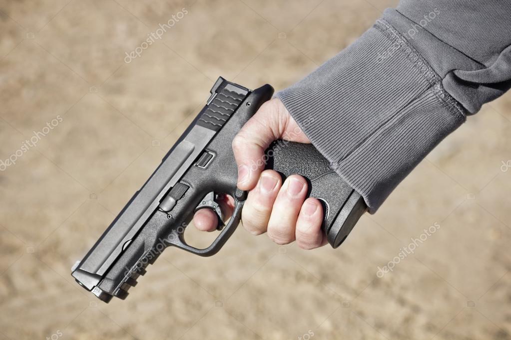 Hand with a gun — Stock Photo © yobro10 #40841253