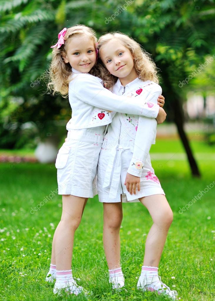 Portrait of two sisters twins in the summer Stock Photo by ©zagorodnaya ...