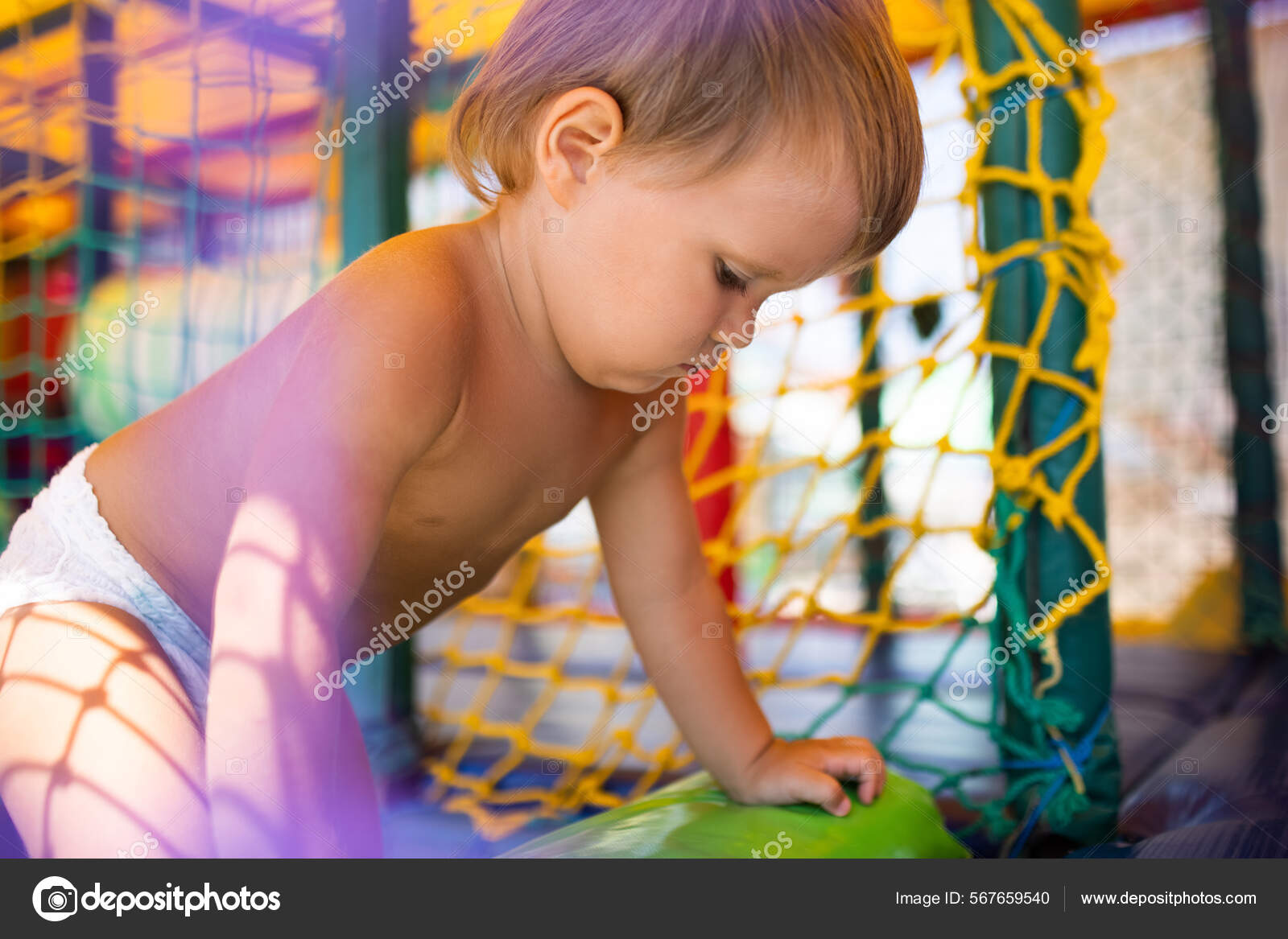 Boy in diaper with ball playing in playroom on weekend — Stock Photo ...