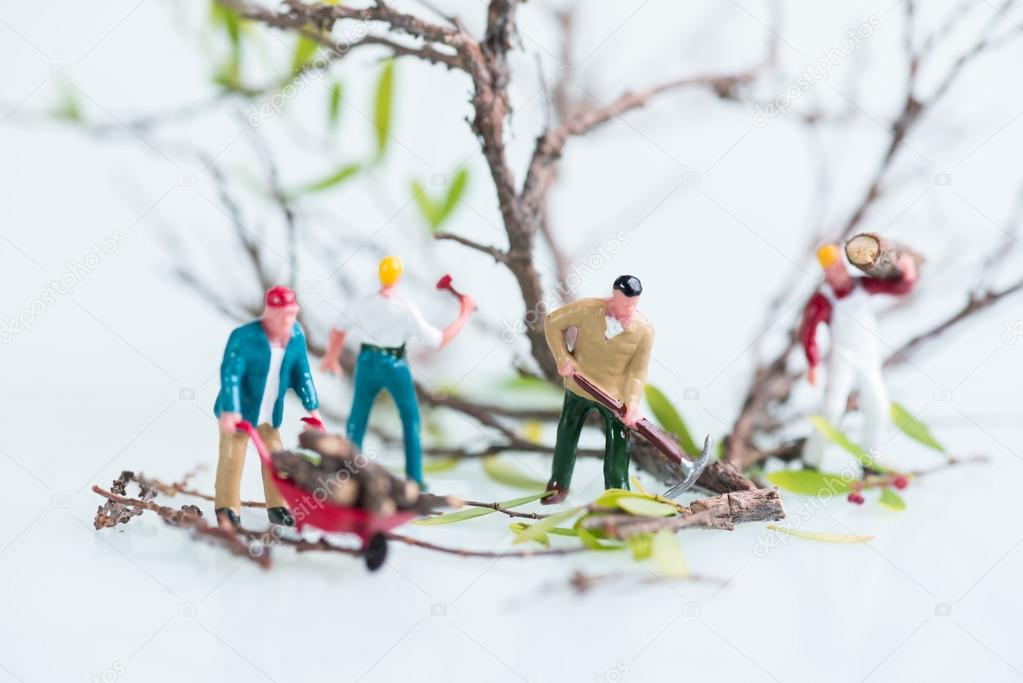 Miniature workmen cutting and felling trees close up — Stock Photo ...