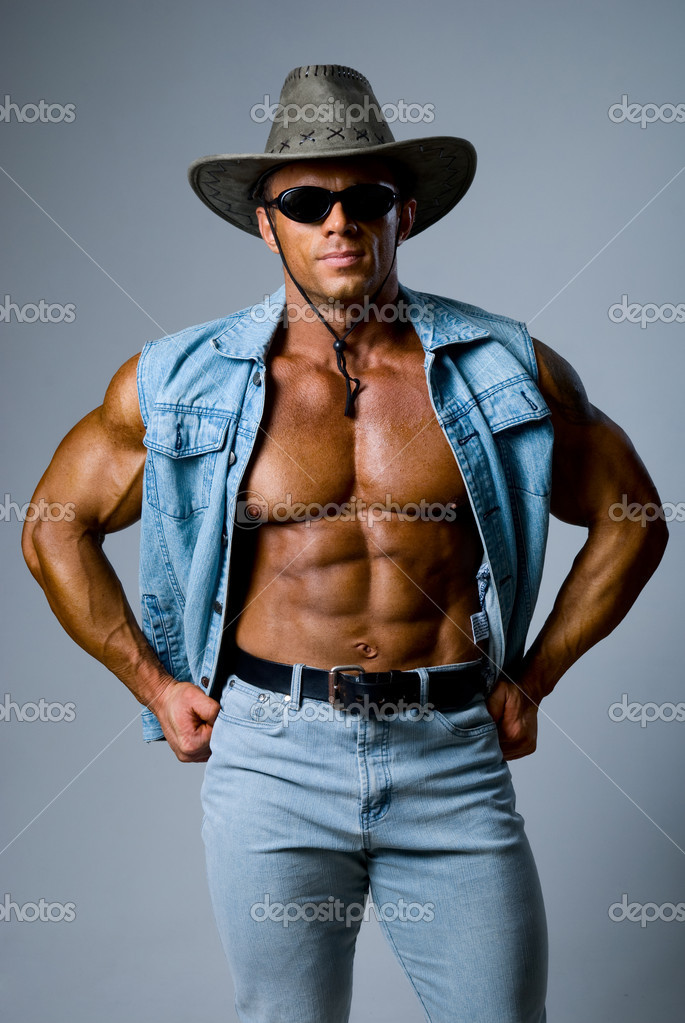 Muscular man in a cowboy hat — Stock Photo © kanzefar #15839649
