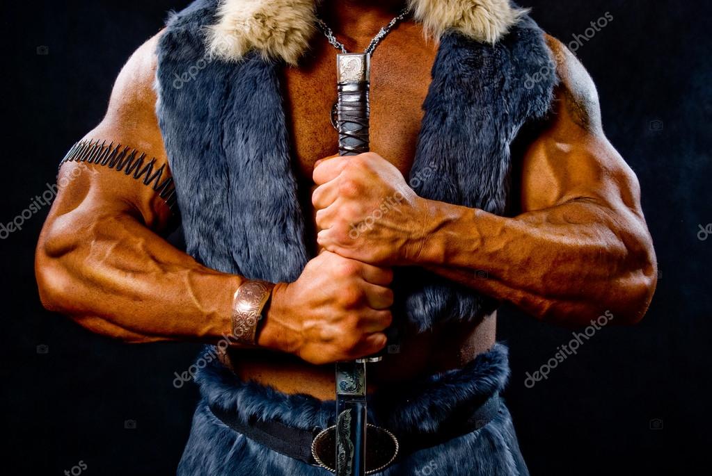 Muscular man warrior with a sword Stock Photo by ©kanzefar 16931309