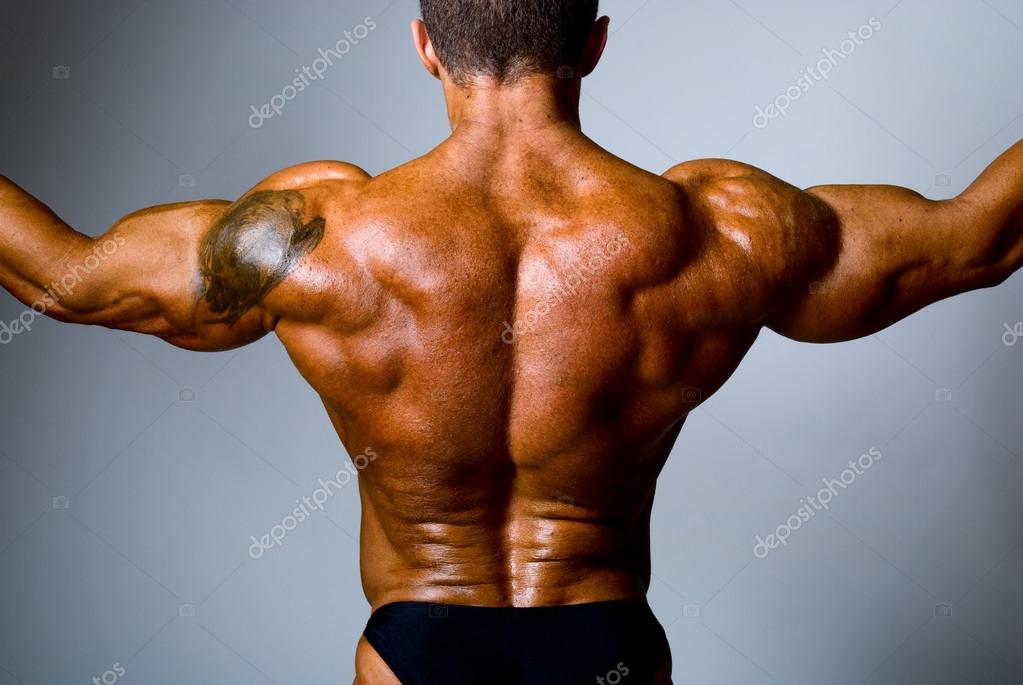 The back muscular man with a tattoo on her shoulder — Stock Photo ...