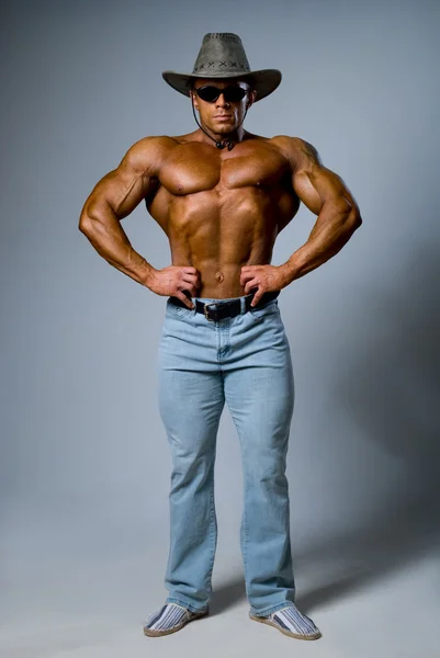 Muscular male in a hat and sunglasses — Stock Photo © kanzefar #18295441