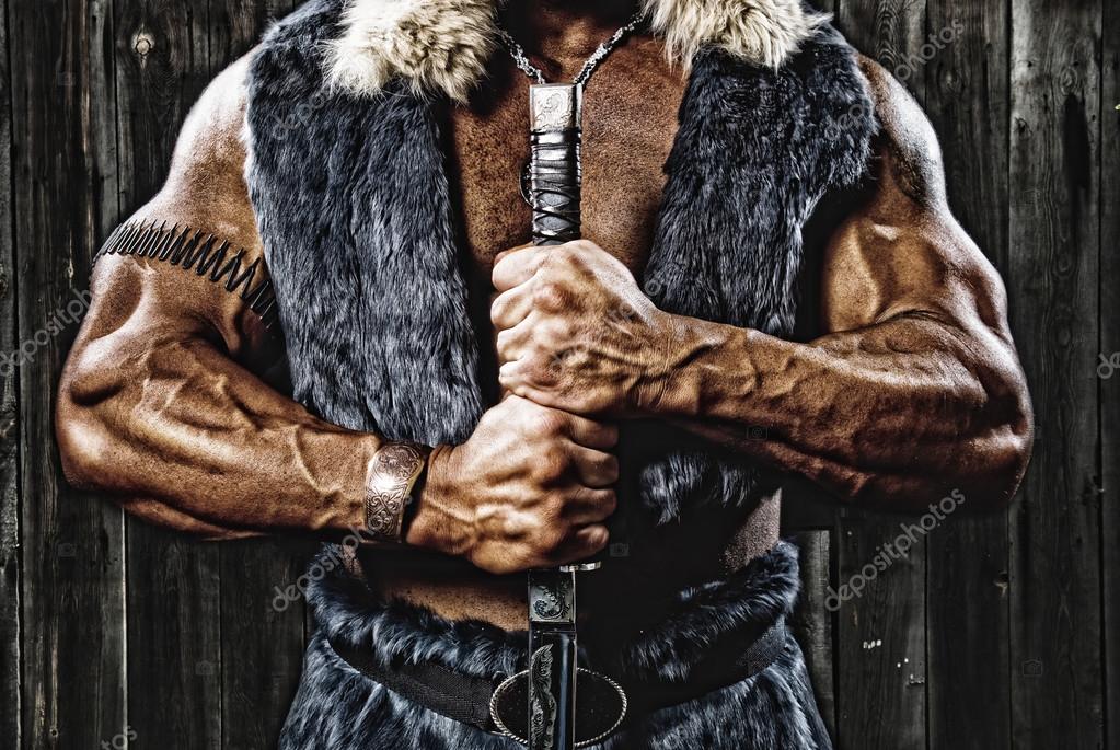 Strong muscular man defender warrior with sword in hand Stock Photo by ...