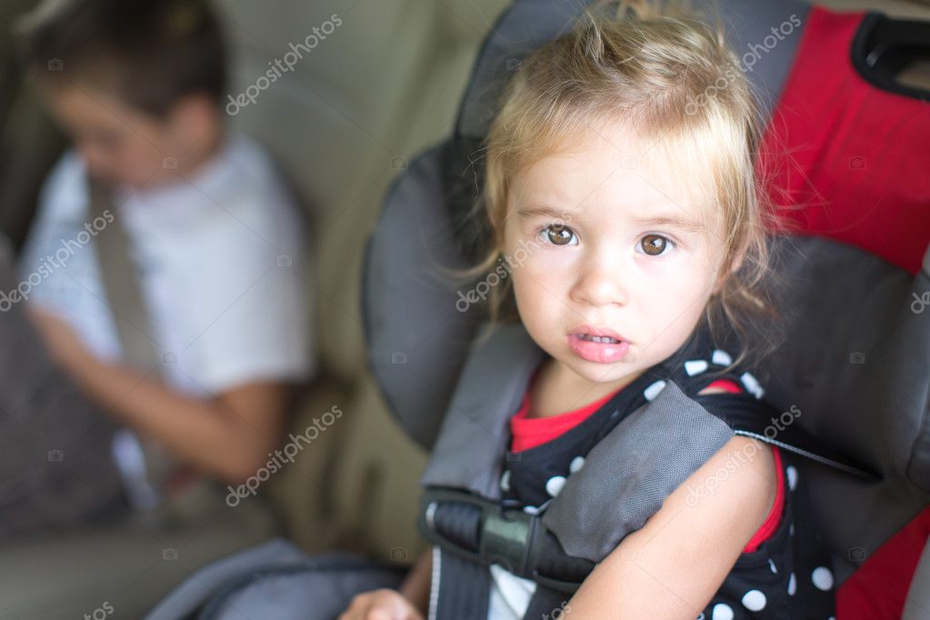 Little girl strapped into a childs safety seat — Stock Photo © oocoskun ...