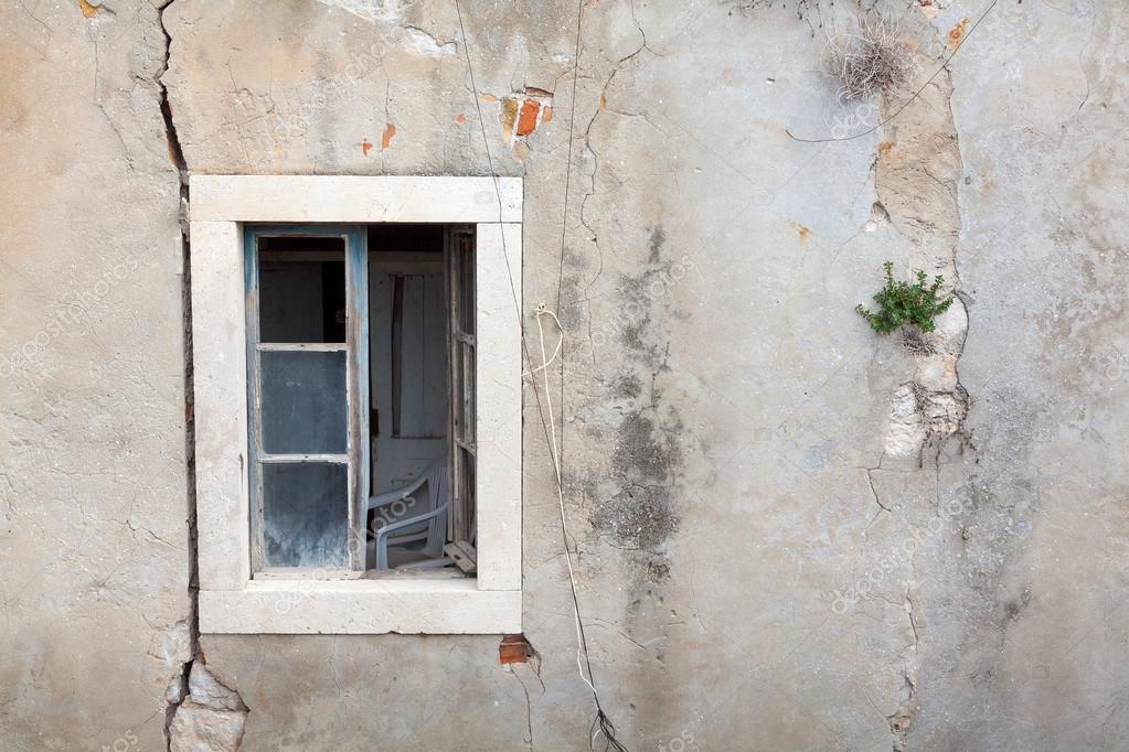 Abandoned building with cracked walls and open window Stock Photo by ...