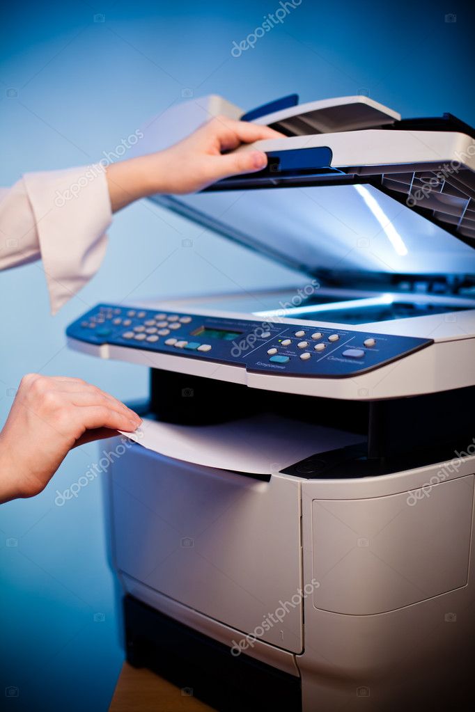 Woman's hand with working copier — Stock Photo © Baton72 #13700650