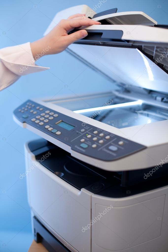 Woman's hand with working copier — Stock Photo © Baton72 #14379167