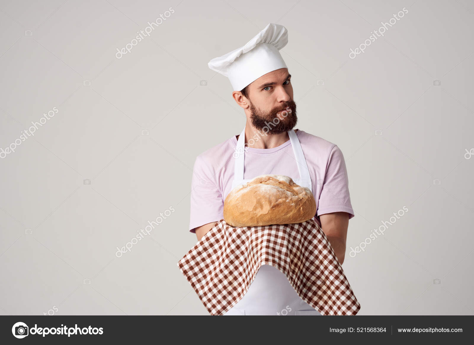 A man in a cooks uniform with bread in his hands baking cooking work ...