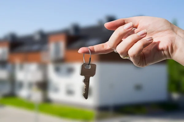 Woman's hand holding keys to new house - Stock Image - Everypixel