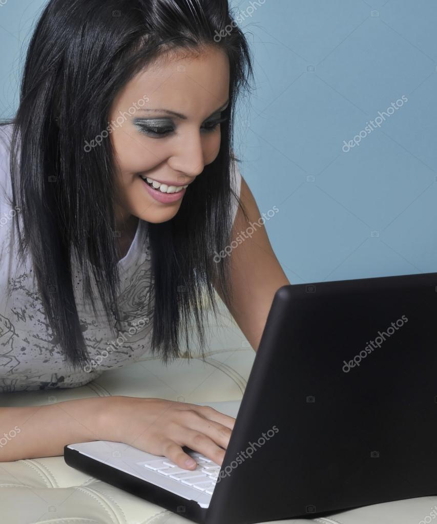 Young woman smiling using lap top computer — Stock Photo © AVFC #24805361