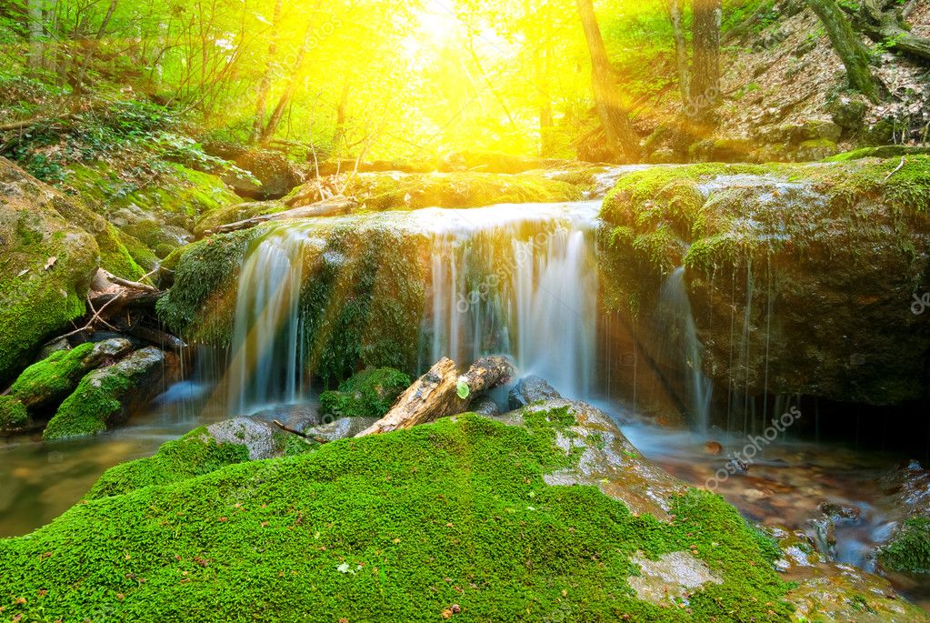 Small beautiful waterfall in a rays of sun — Stock Photo © york_76 ...