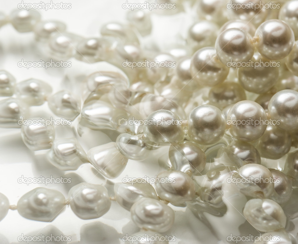 Shining string of white pearl in water — Stock Photo © Garsya #12589327