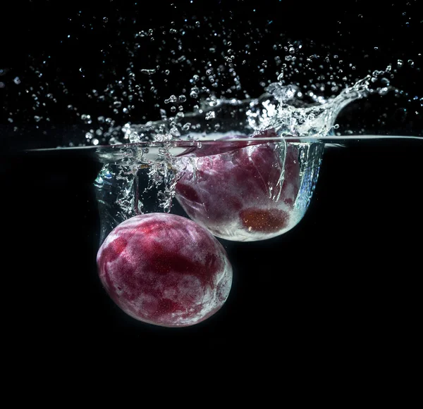 Plums in water splash Stock Photo by ©Garsya 42119063