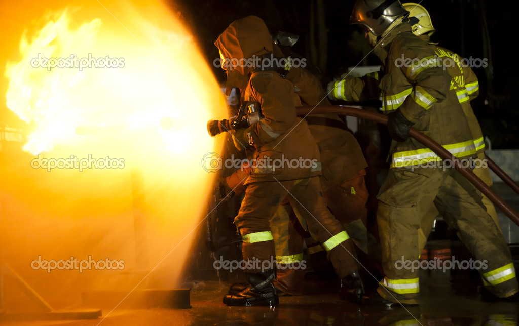 Firefighters attack a propane fire during a training exercise. — Stock ...