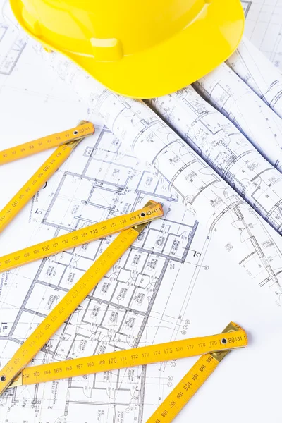 Construction tools with metric folding ruler and architectural drawings ...