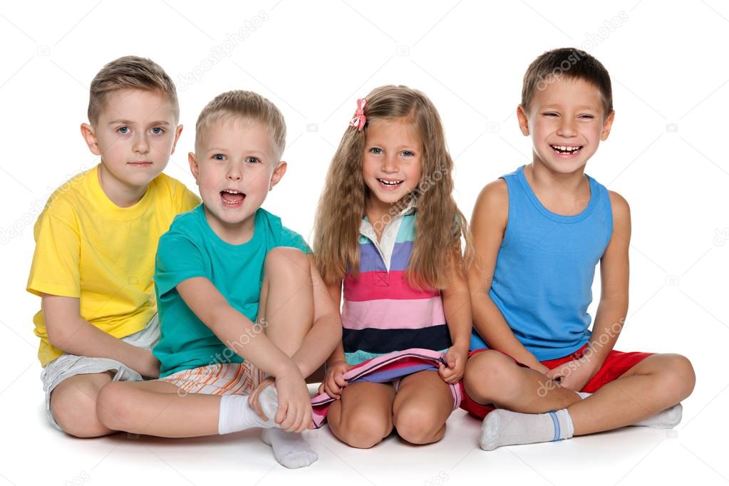 Sitting four cheerful children Stock Photo by ©SergiyN 39923243
