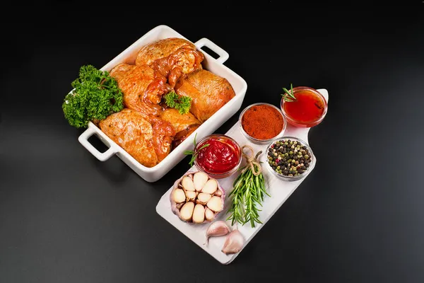 Raw chicken thighs marinated in red sauce. Chicken semi-cooked thighs ...