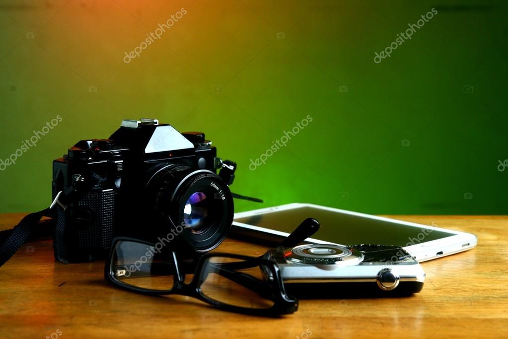Camera, tablet and eyeglasses — Stock Photo © junpinzon #50139371