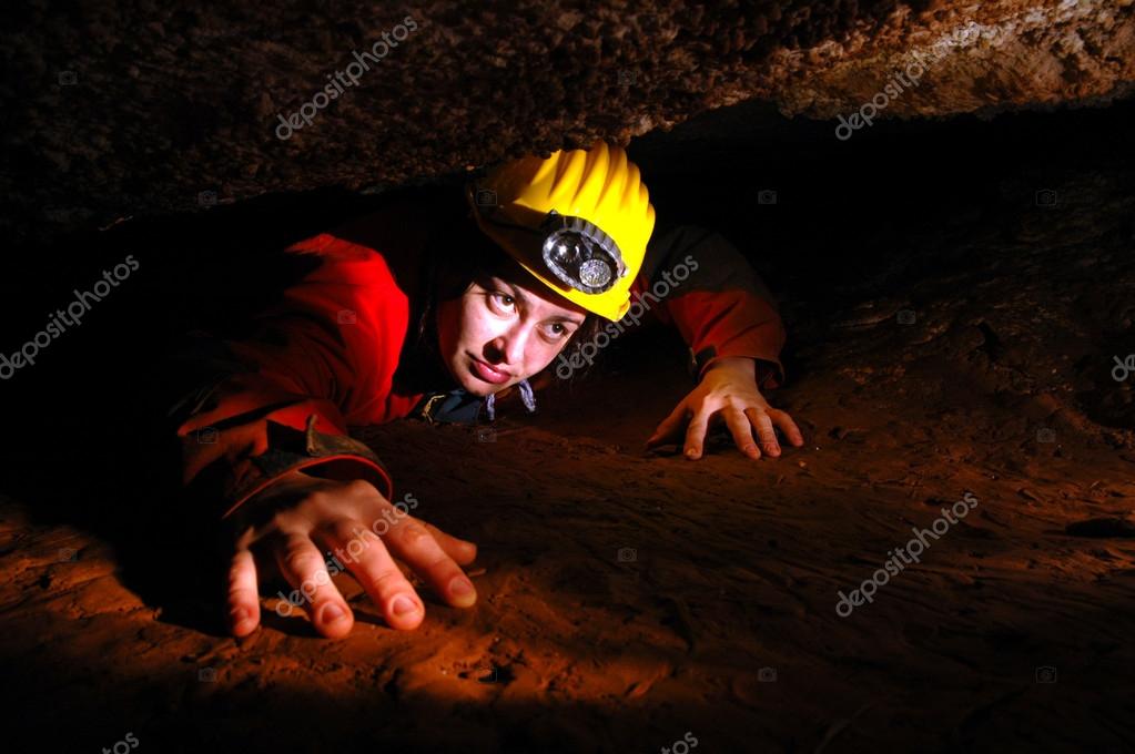 Narrow cave passage with a cave explorer — Stock Photo © salajean #47004133