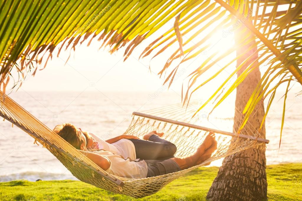 Couple relaxing in tropical hammock — Stock Photo © EpicStockMedia ...