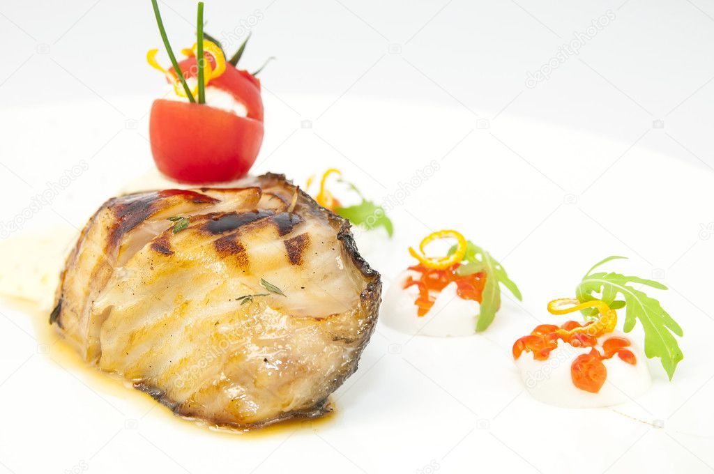 Roasted fillet of grilled fish in a white sauce Stock Photo by ...