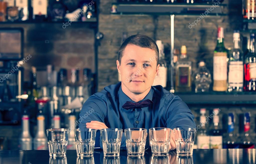 Young man working as a bartender Stock Photo by ©Lester120 47463005