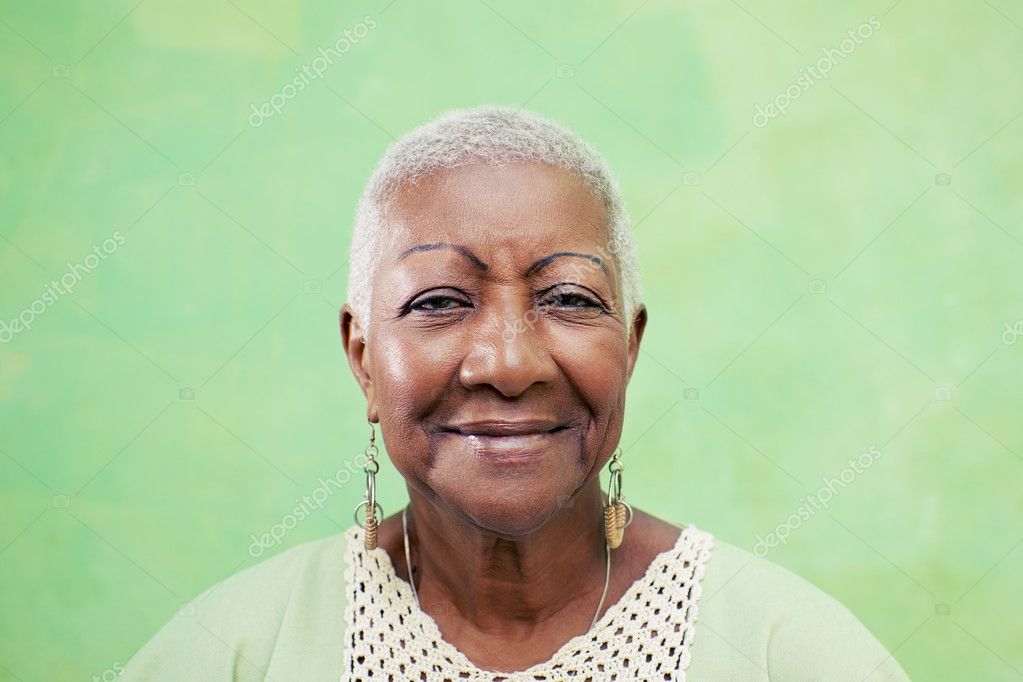 Portrait of senior black woman smiling at camera on green backgr Stock ... Portrait of senior black woman smiling at camera on green backgr Stock ...