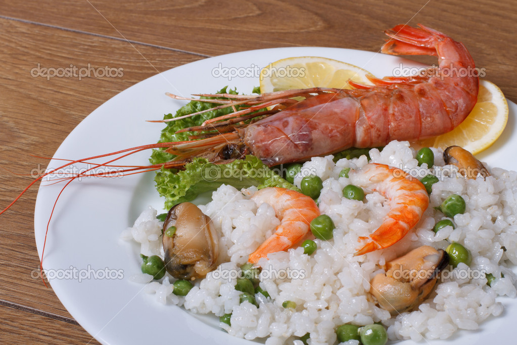 Spiny lobster, prawns and mussels with rice Stock Photo by ©lenyvavsha ...